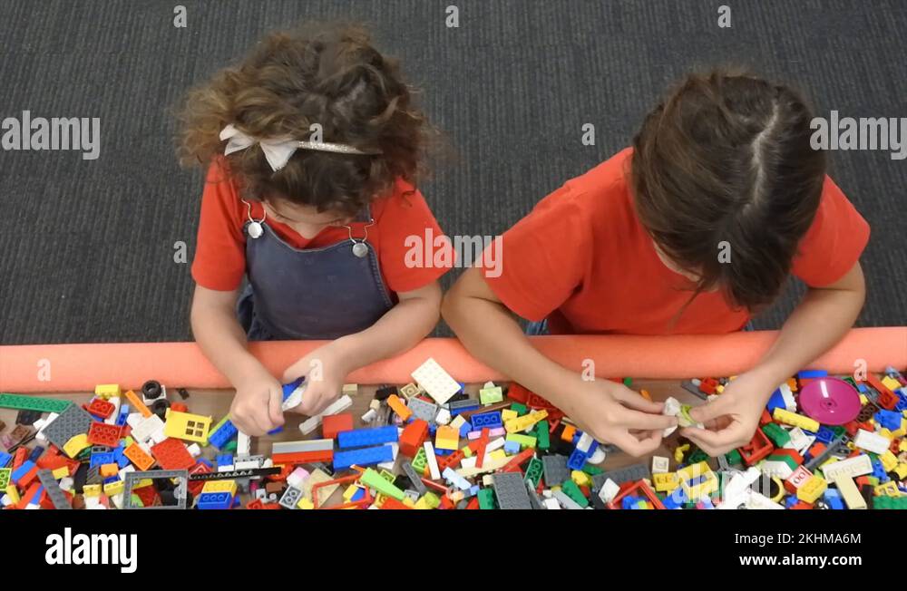 Two girls playing with lego bricks Stock Video Footage - Alamy
