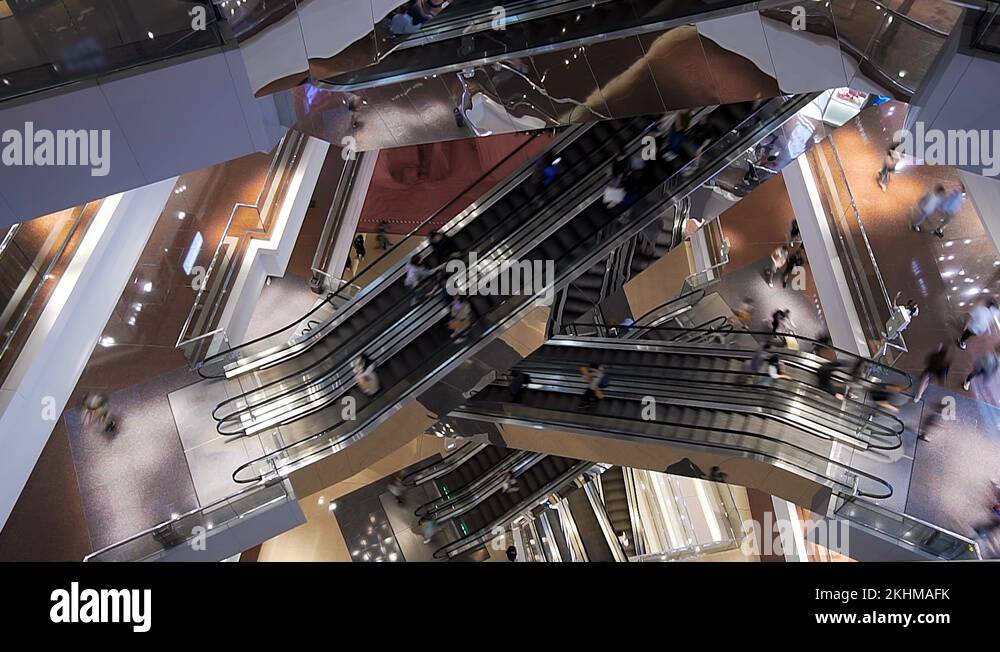 Shopping mall crowd of people on escalators. Consumption concept. Rush ...