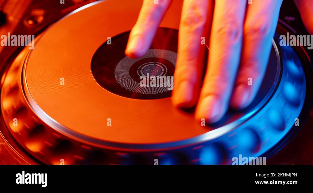Disc jockey working on his professional mixer controller, sliding the ...