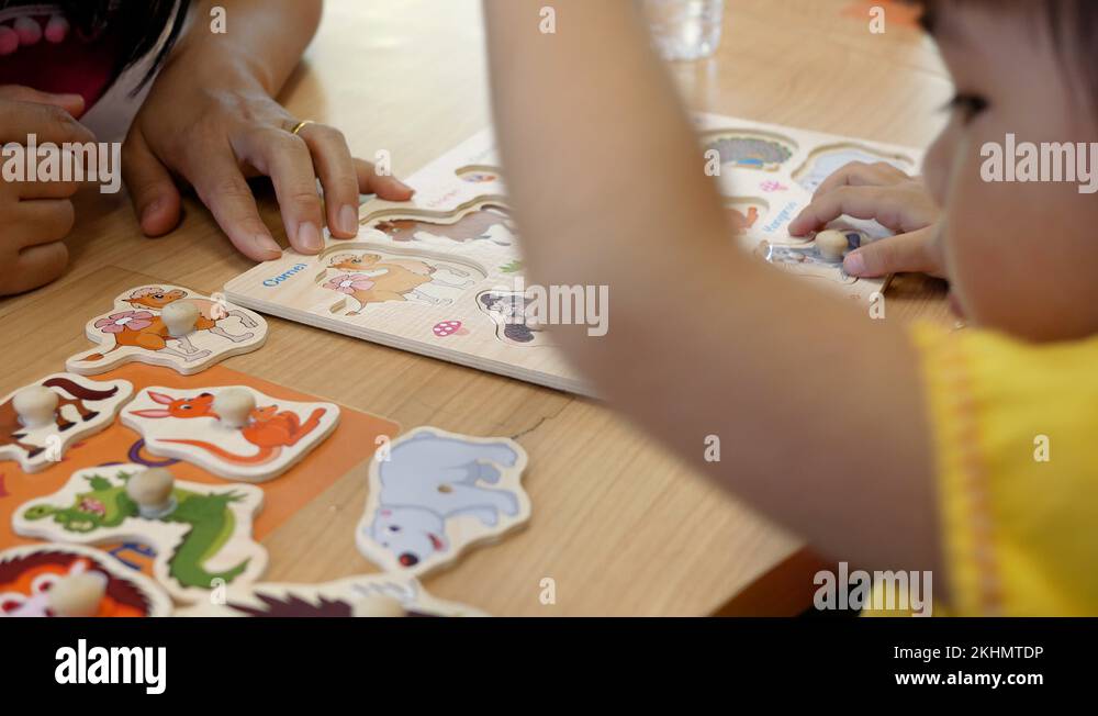 Child playing with montessori wood material for the animal learning in ...