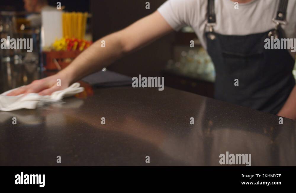 Bartender in the apron wipes bar counter with a rag, close up Stock ...