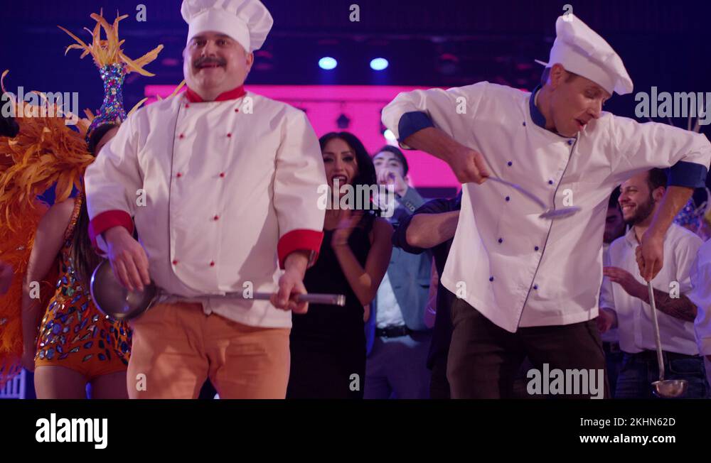 Cook and waiter dancers having fun dancing at a colorful party Stock ...