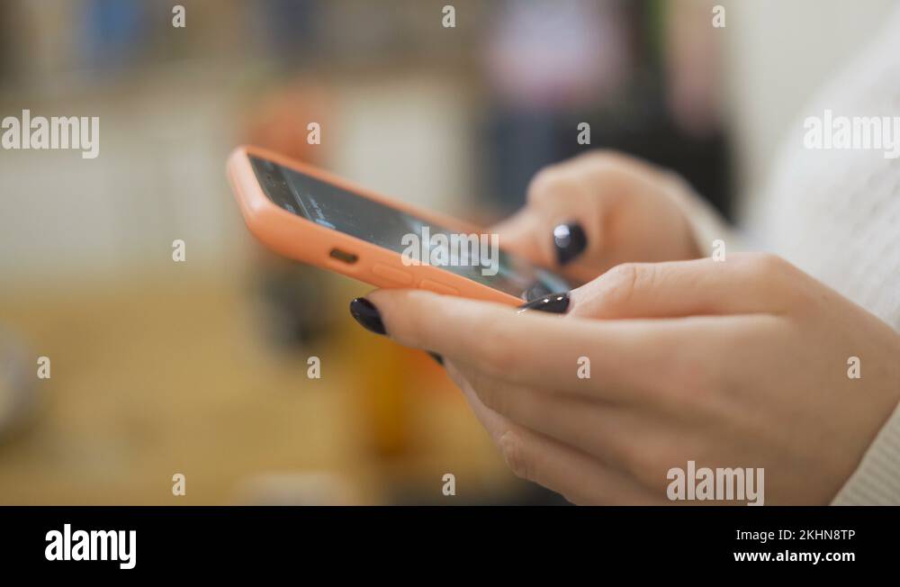 Girl hands with nail polish swiping trough photos on her smartphone ...