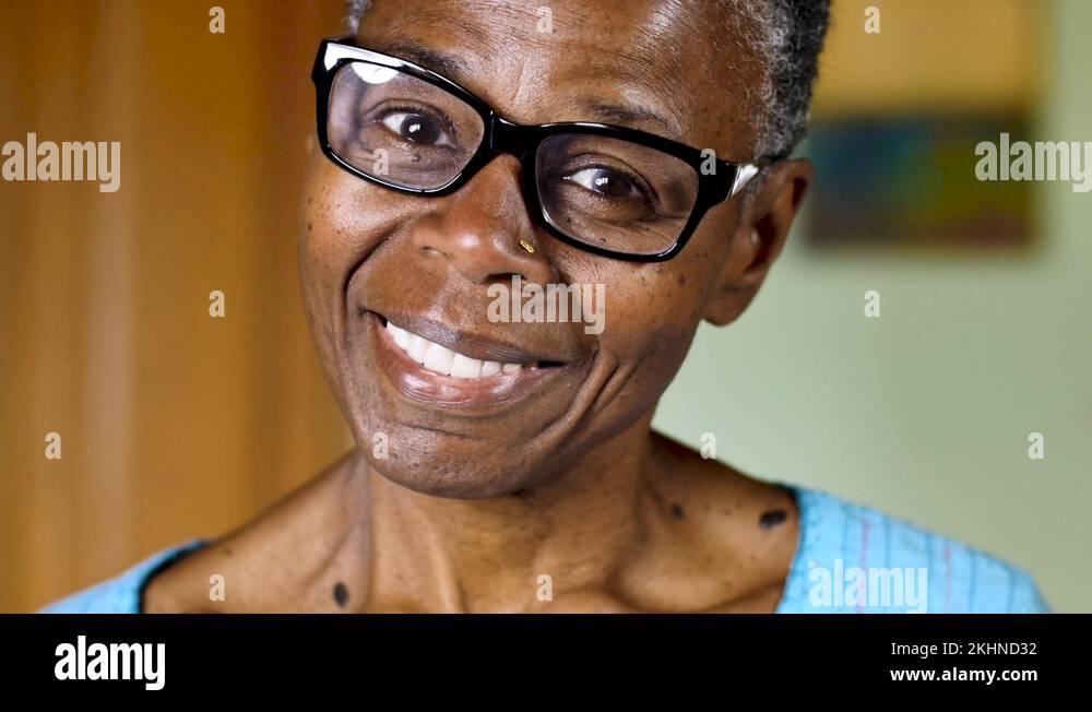 Beautiful black woman in her 60s smiling and looking at the camera ...