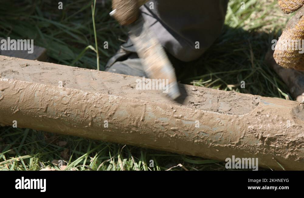 Geologist preparing drill pipe to take out core samples for geological ...