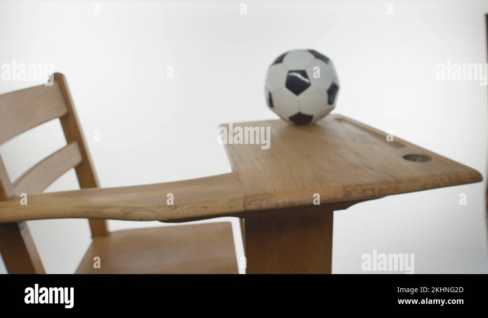Ramped speed soccer ball on school desk white background Stock Video ...