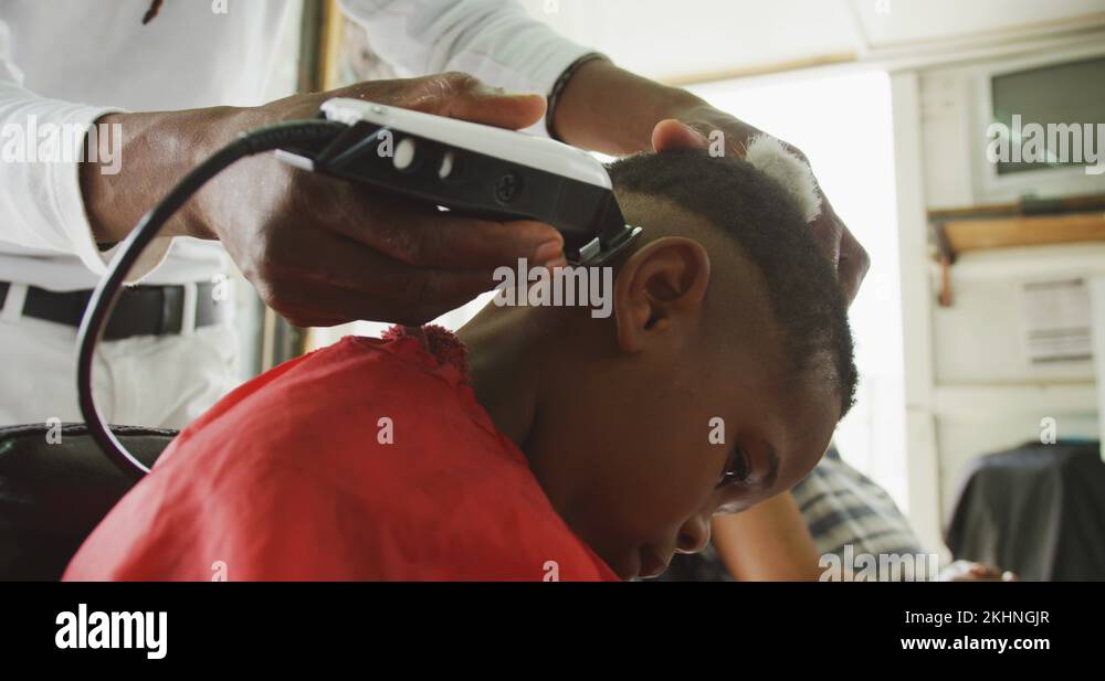 African man cutting African boy hair Stock Video Footage - Alamy
