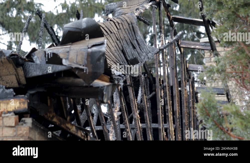 Burnt roof of house close up destroyed by fire damage. Shingles and ...