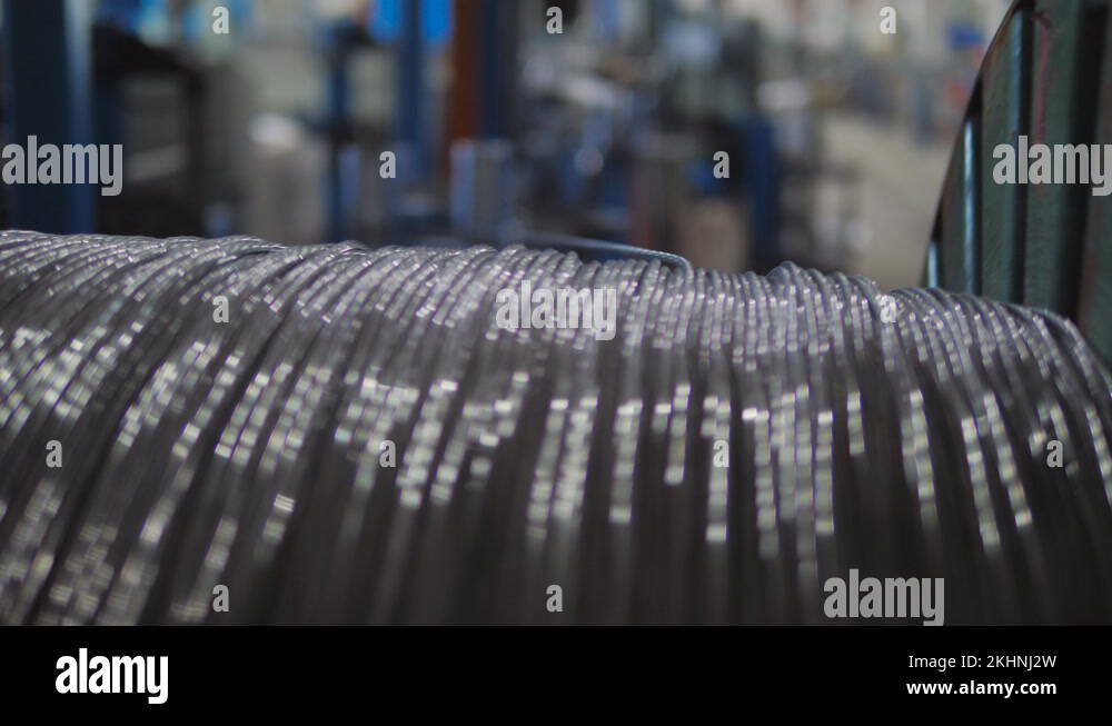 Aluminum wire pulley rolling. Winding the aluminum cable onto the reel ...