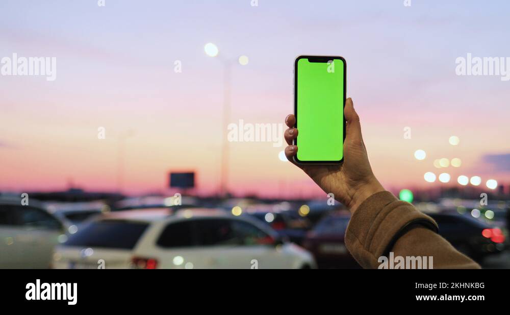 Vertical black smartphone with chroma key on the screen is in the ...