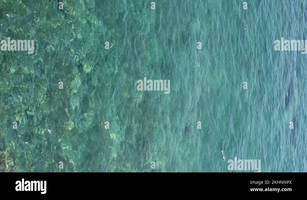 Sea water surface top view near coast. Vertical video Stock Video ...