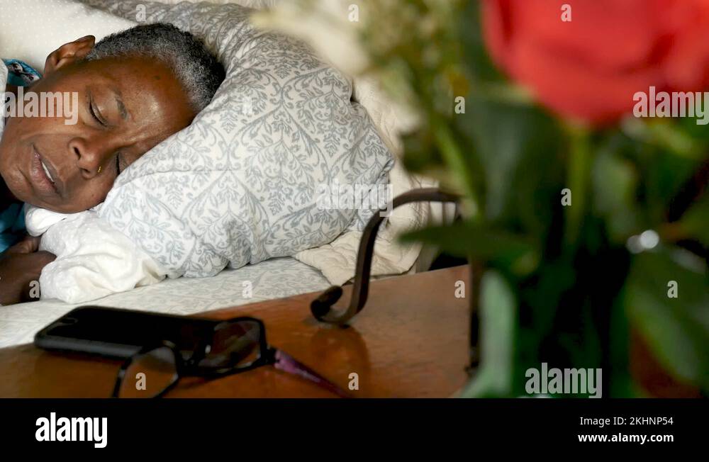 African American black woman checking her phone and going back to sleep ...