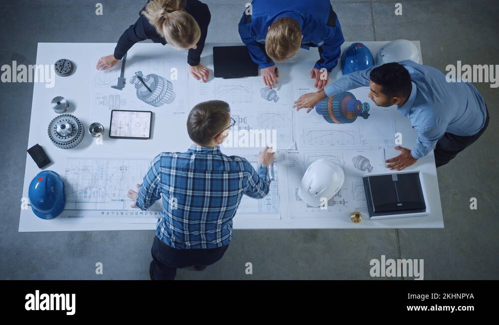 Team of Industrial Engineers Lean on Office Table, Analyze Machinery ...