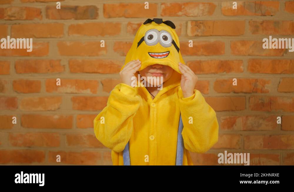 Cheerful boy in minion pajama smiling. Cartoon character costume. Crazy ...