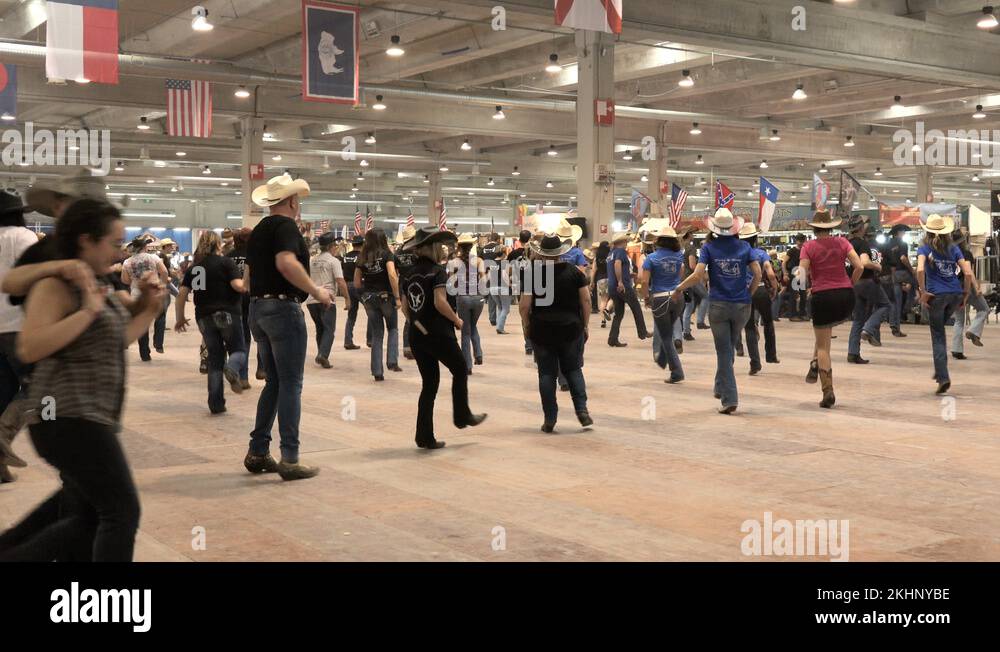 Couples and group dancing bluegrass music, line dance at a country ...