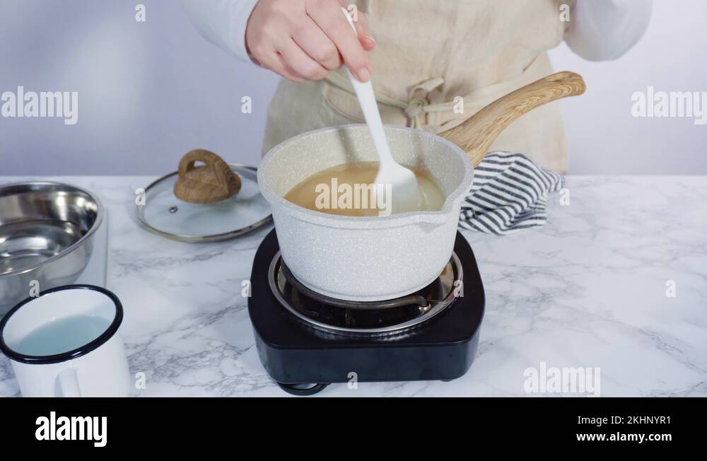 Caramelizing sugar in a small cooking pot over the small electric stove ...
