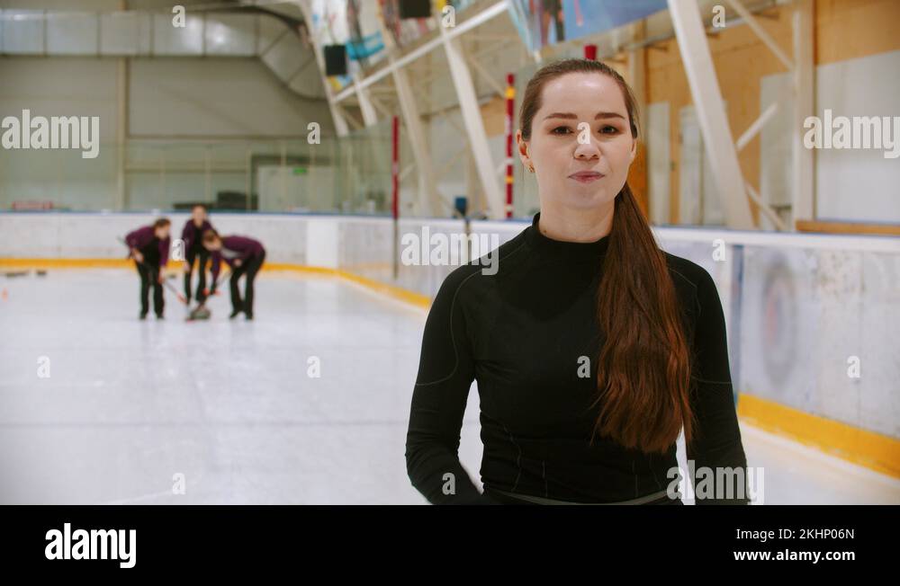 Curling training - the judge standing on the ice rink looking in the ...