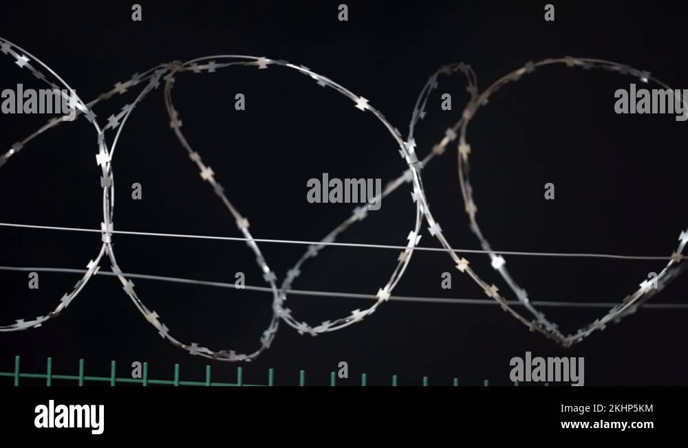 Perimeter security fencing system. Razor wire on top of perimeter fence ...
