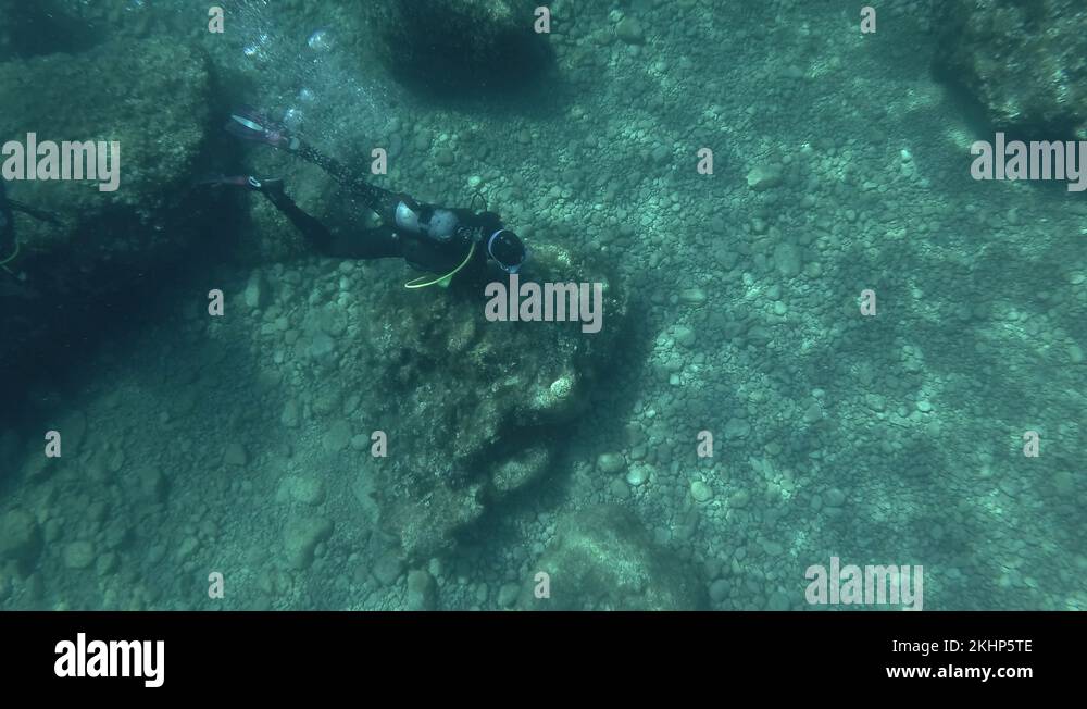 beginner scuba diver swims for experienced diving guide. Top View ...