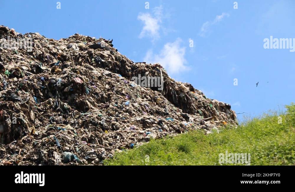 a pile of garbage from the surrounding community becomes a mountain of ...