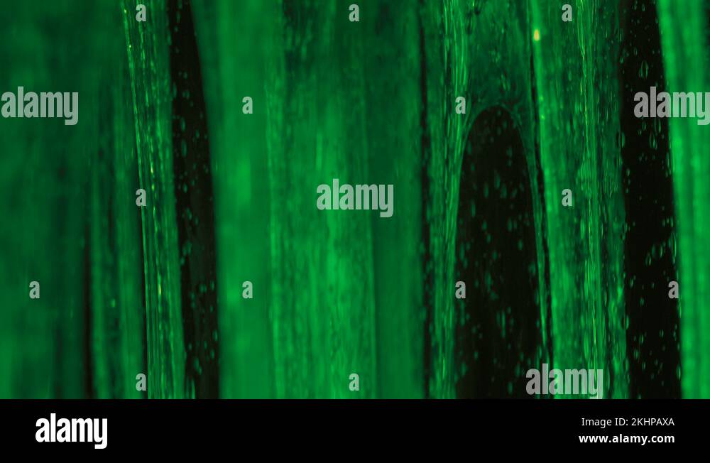 Colored sticky mucus stretches from top to bottom on the dark ...