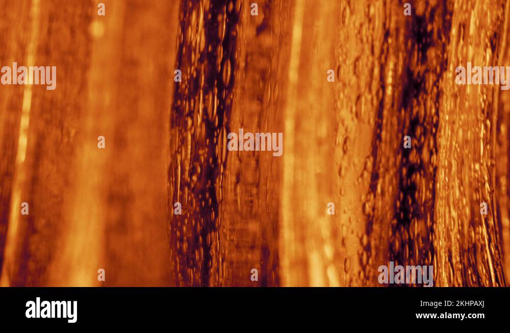 Colored sticky mucus stretches from top to bottom on the dark ...