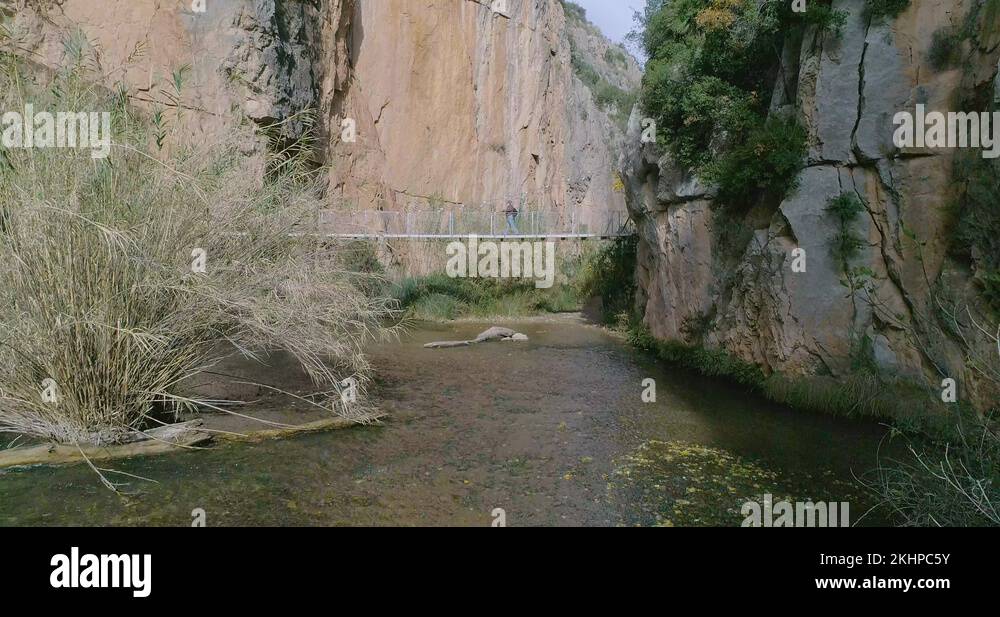 Drone advancing inside the river between and elderly person walking ...