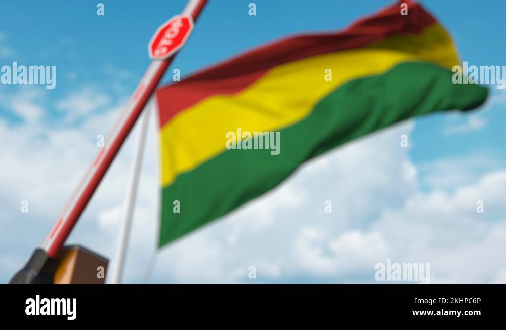 Closing boom barrier with stop sign against the Bolivian flag ...