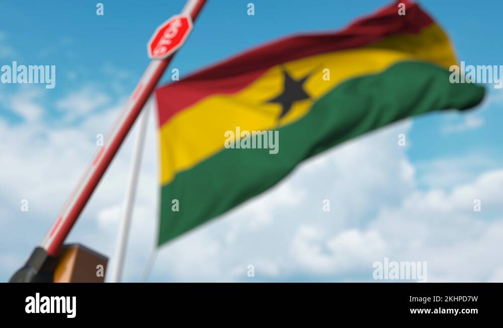 Closing boom barrier with stop sign against the Ghanaian flag ...