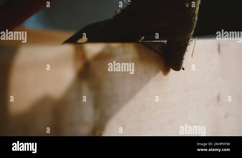 Cinematic close-up male hands in gloves cutting wood plank angles with ...