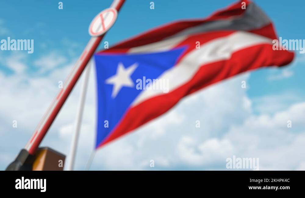Closing boom barrier with stop immigration sign against the Puerto ...