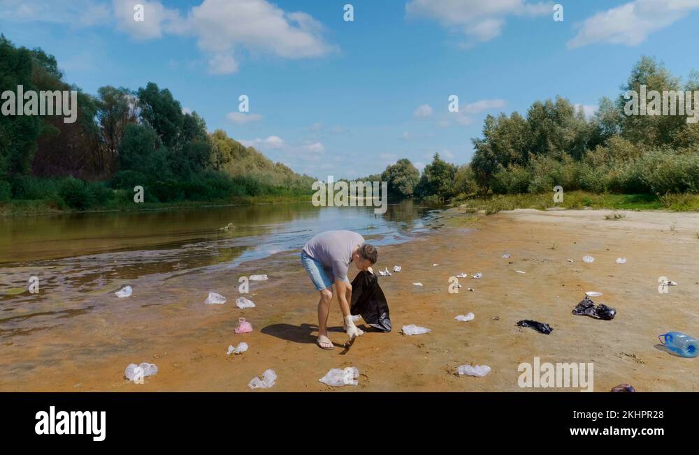 Angry man collects plastic trash on banks of polluted river, then drops ...