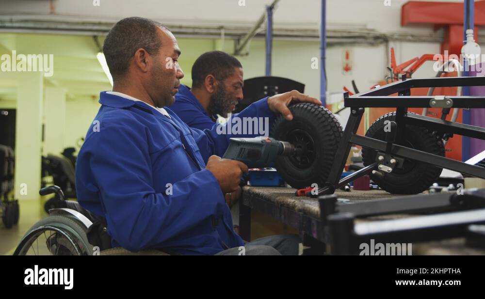 Mechanics assembling the wheels with an object Stock Video Footage - Alamy