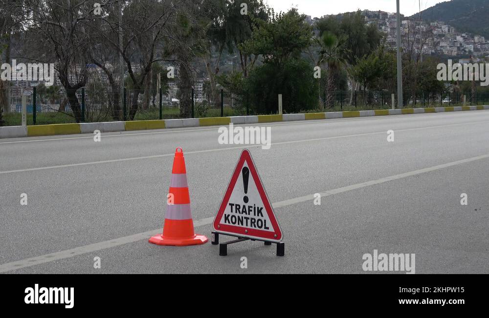 Cars passing a pylon and a traffic control sign Stock Video Footage - Alamy