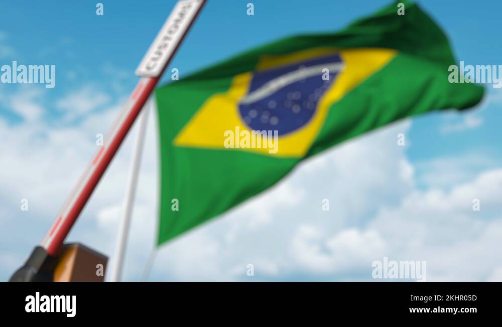 Closed boom gate with CUSTOMS sign on the Brazilian flag background ...
