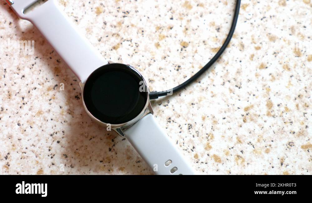 smart watch wireless charging on charging pad on kitchen worktop table ...