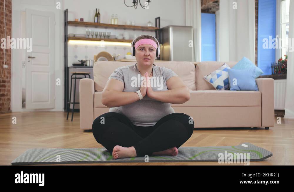 Obese woman training at home, meditating after exercises Stock Video ...