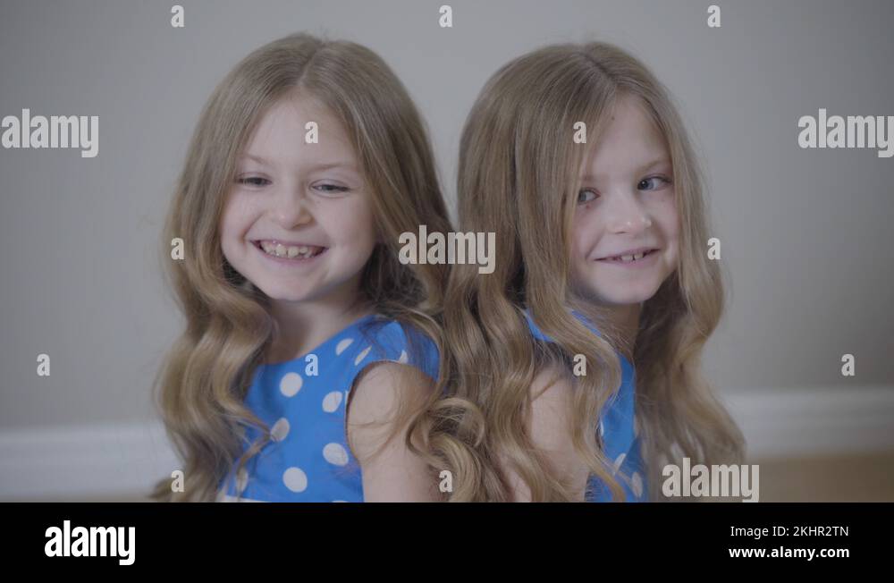 Twin sisters sitting back back Stock Videos & Footage - HD and 4K Video ...