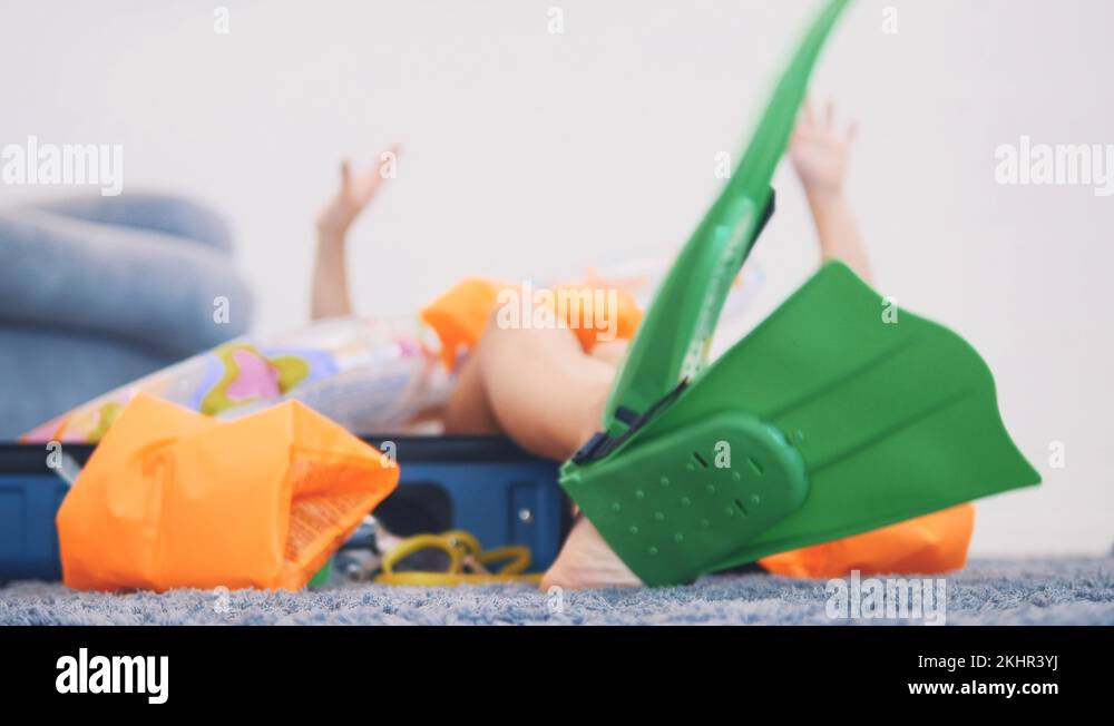 Little girl, wearing swimming suit, flippers and goggles imitating ...