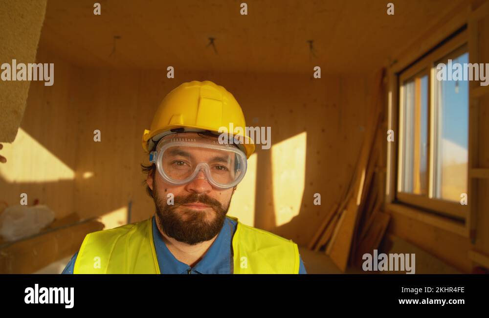 PORTRAIT: Construction worker wearing a hard hat gets struck by a piece ...