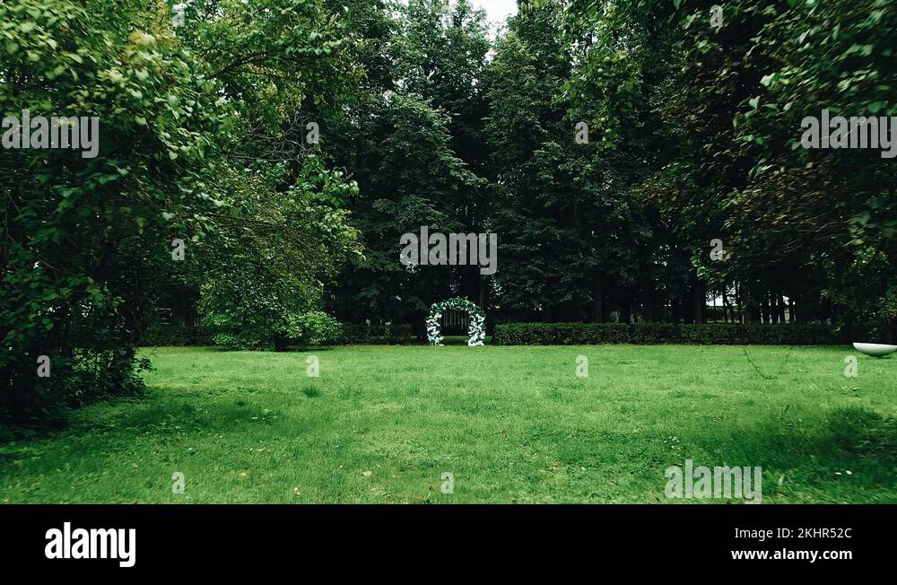 The wedding arch stands on the edge of the Park. The camera zooms in on ...
