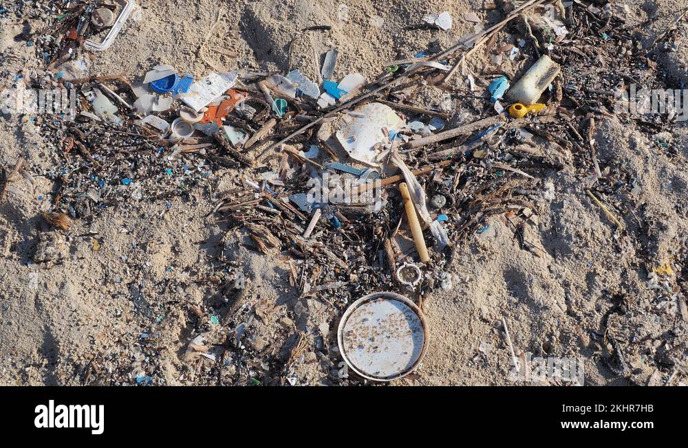 Environmental pollution. Sand beaches polluted with pieces of plastic ...
