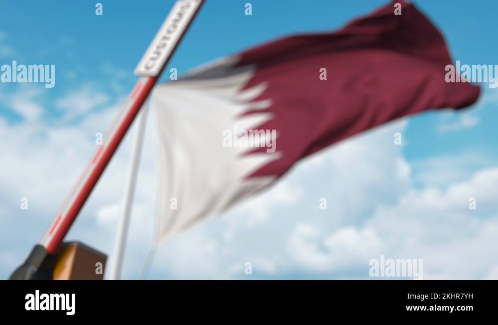 Barrier gate with CUSTOMS sign being closed with flag of Qatar as a ...