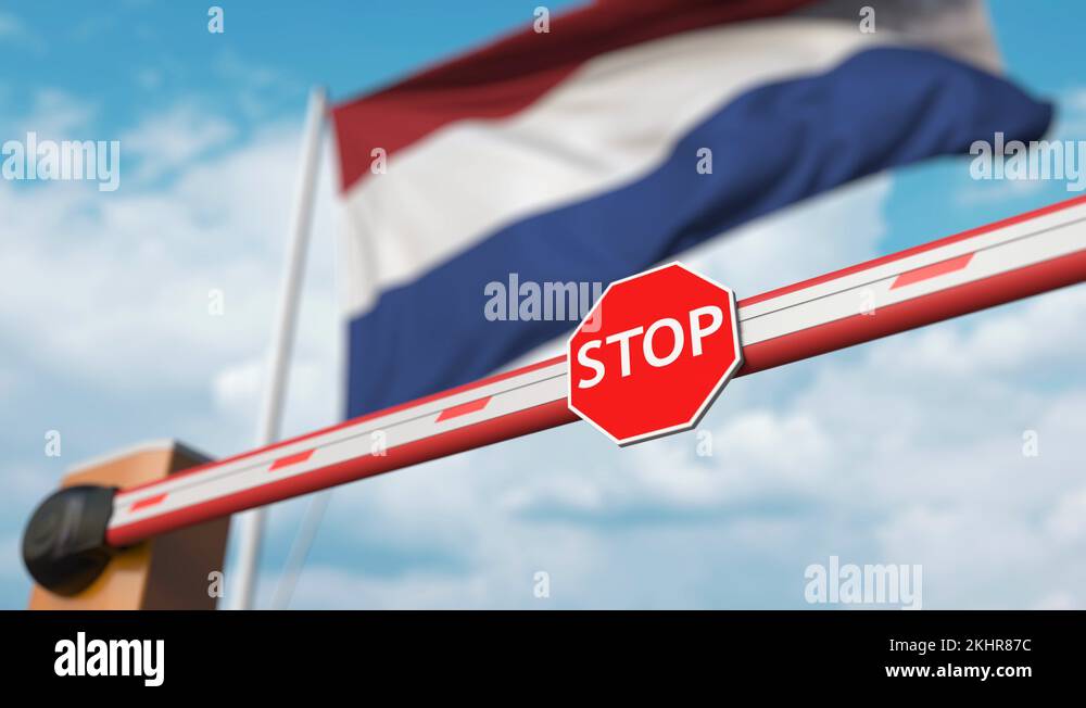 Opening boom barrier with stop sign against the Dutch flag. Free border ...