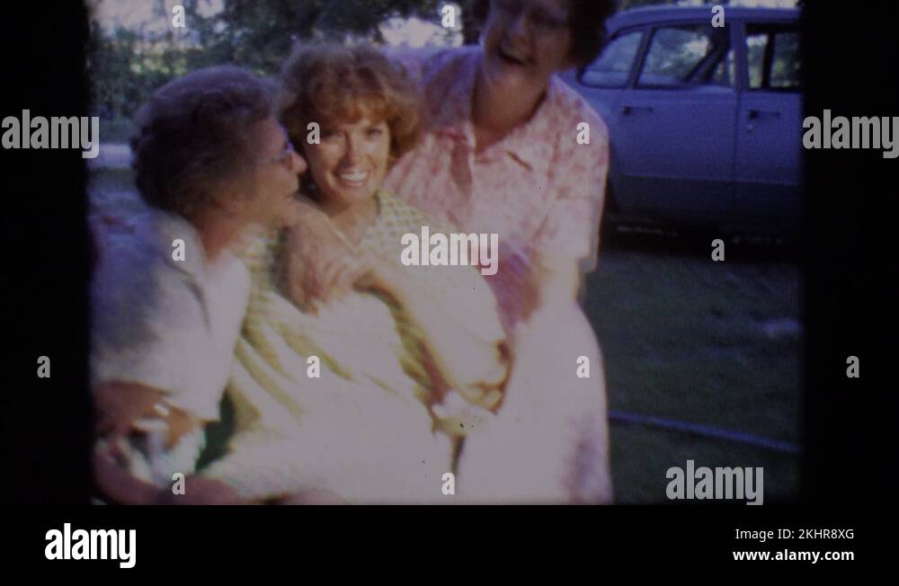 DES MOINES IOWA-1966: A Young Woman Sits In A Front Yard As Two Older ...