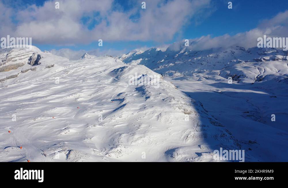 Flight over snow-capped mountains in the Swiss Alps on a winter's day ...