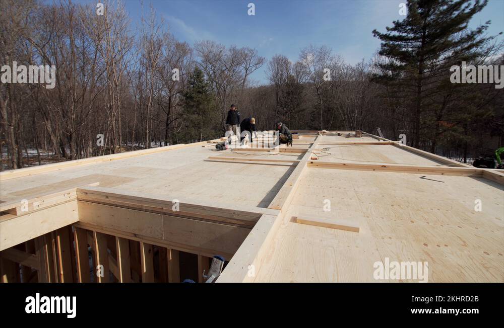 Timelapse: builders attach planks on the second floor of frame house ...