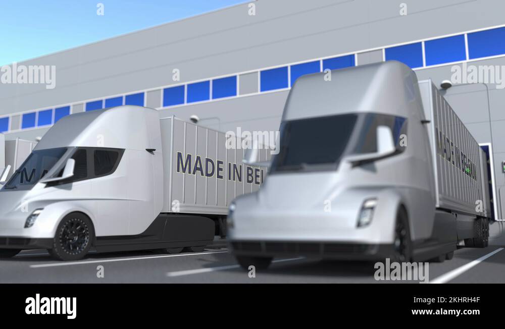 Trailer trucks with MADE IN BELGIUM text being loaded or unloaded at ...