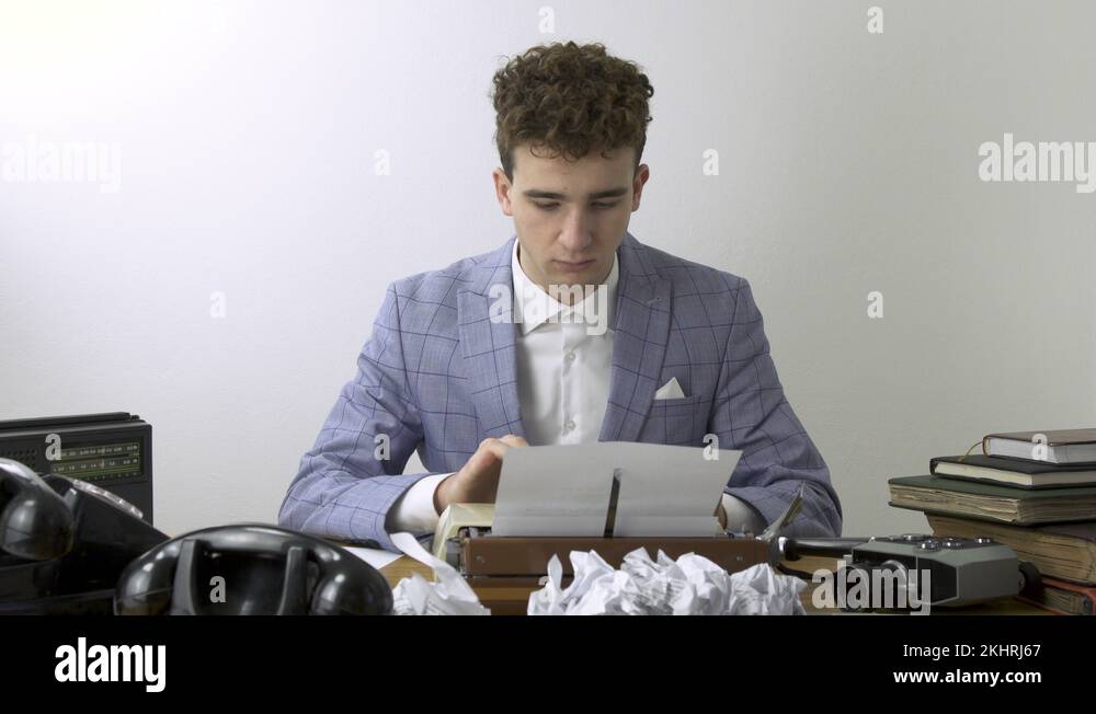 Retro 80s young man Writer thinks over text of book or a script and ...