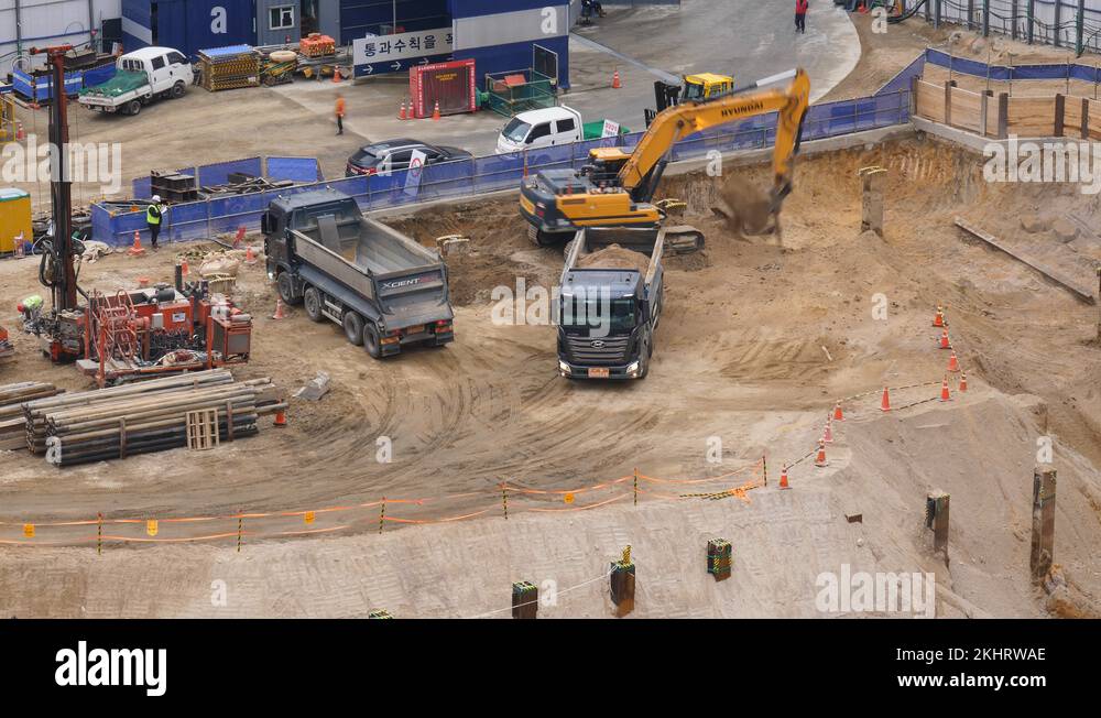 Excavator dig basement area, load ground to tuck. Construction site ...
